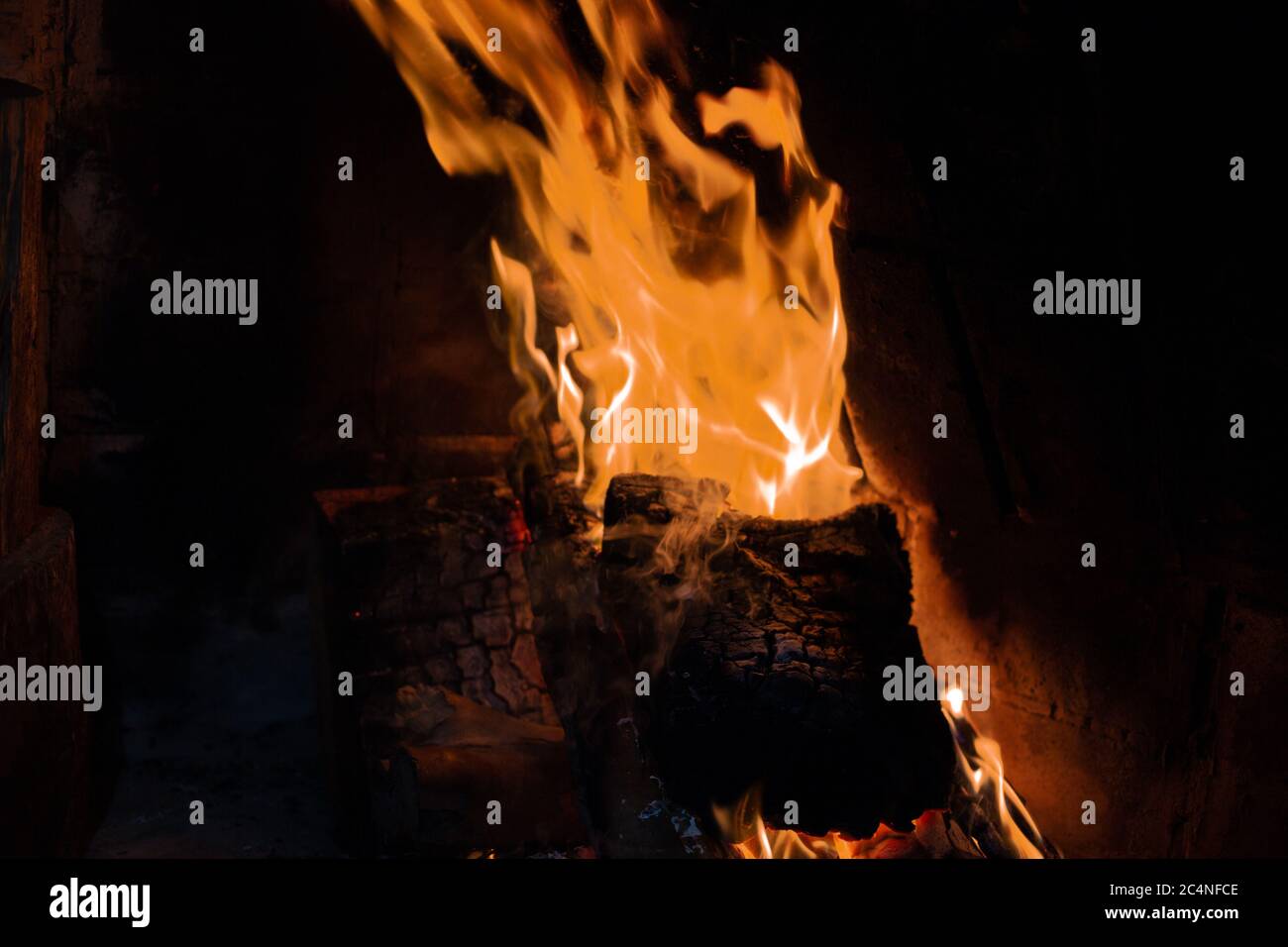 Stone stove with burning charcoal at night time Stock Photo - Alamy