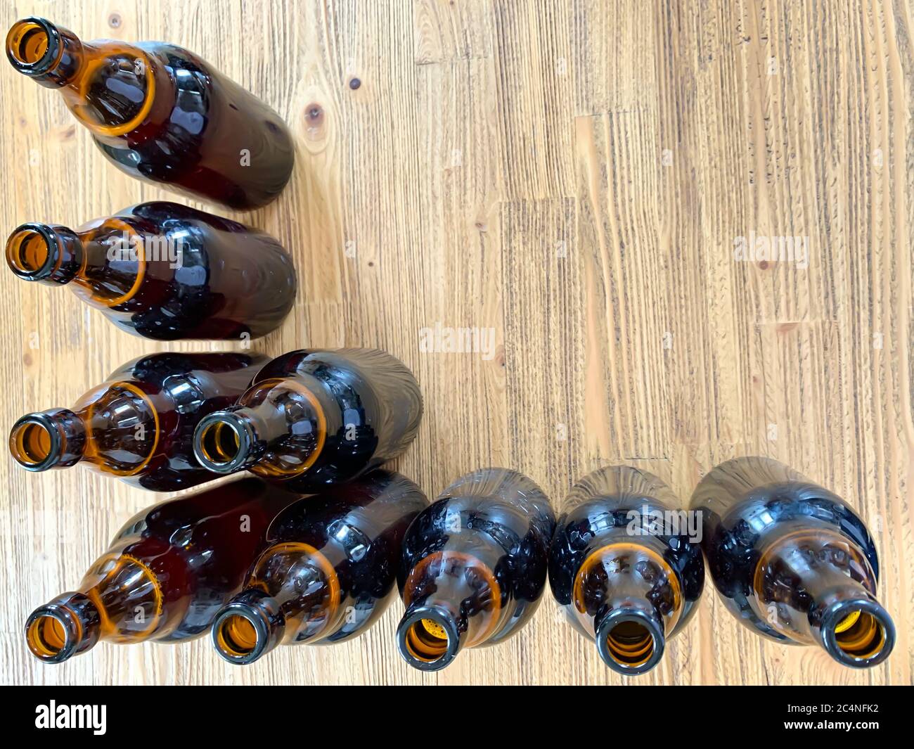 Brown glass craft beer bottle frame top view on a wooden background ...