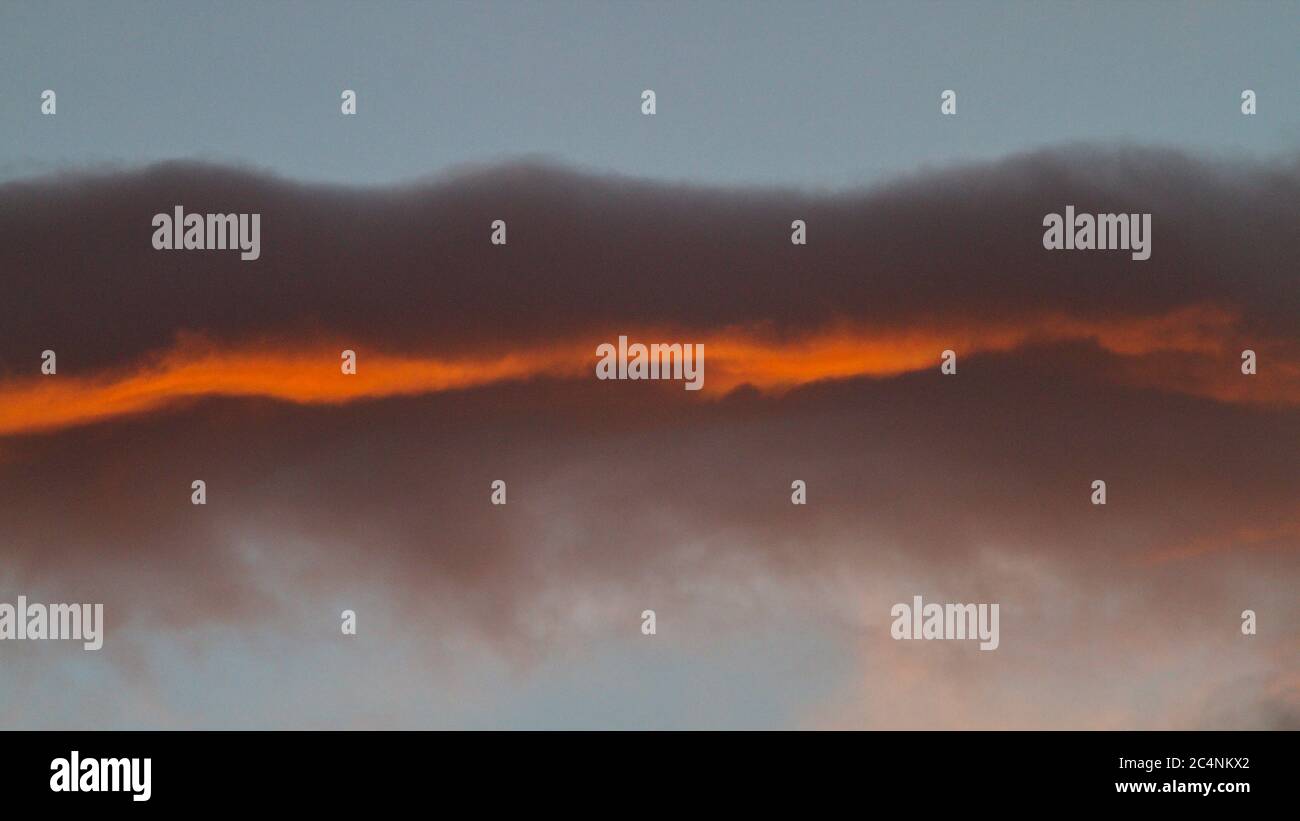 Colorful cloud patterns with golden hour light Stock Photo - Alamy