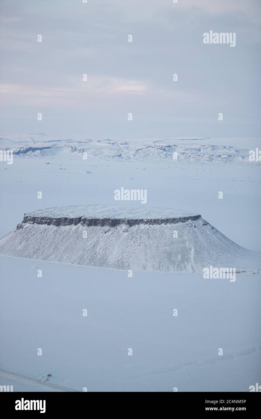 Aerial shot of the Dundas mountain covered in snow in Thule, Greenland ...