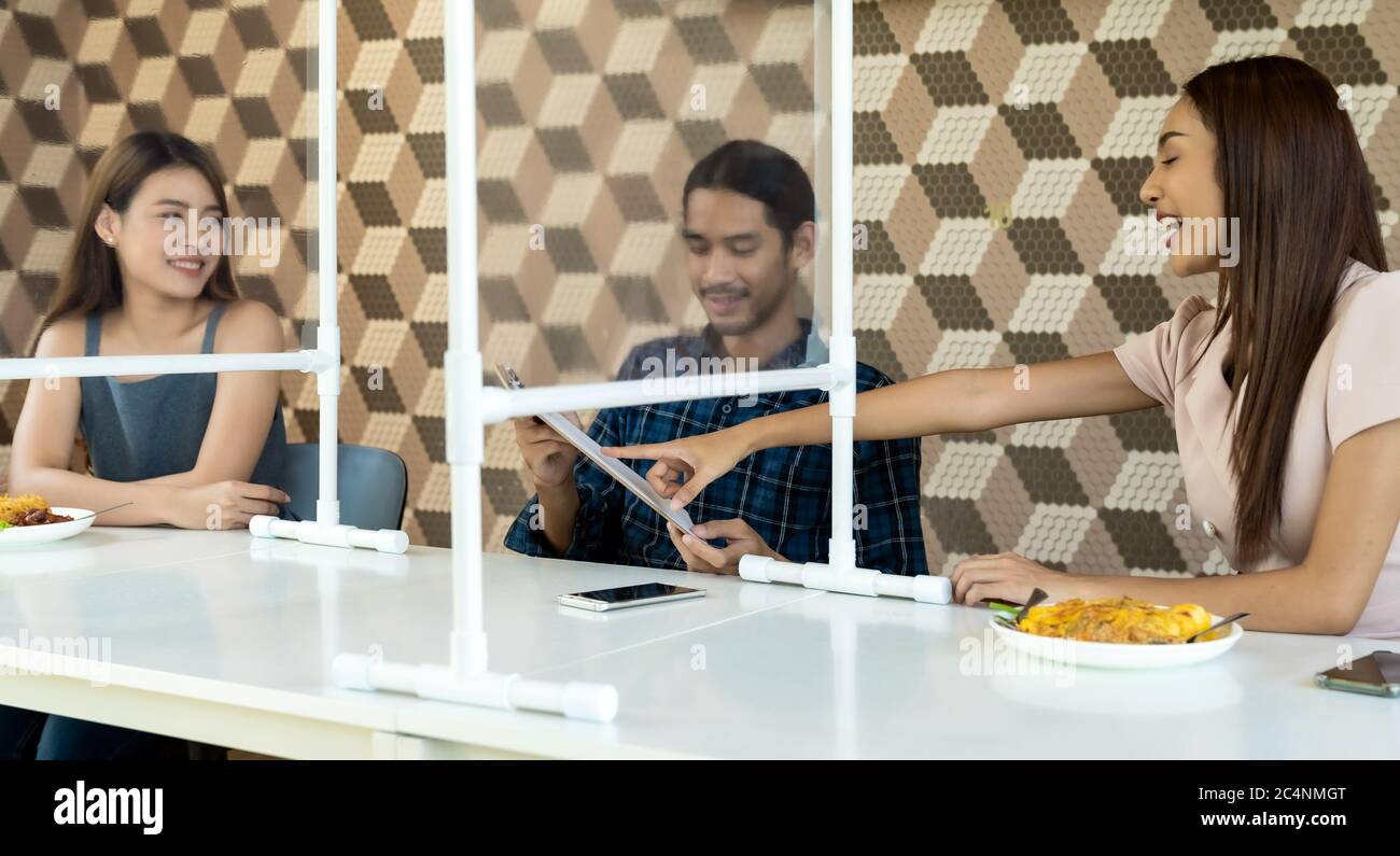 Asian young adult eating out together at new normal social distance ...