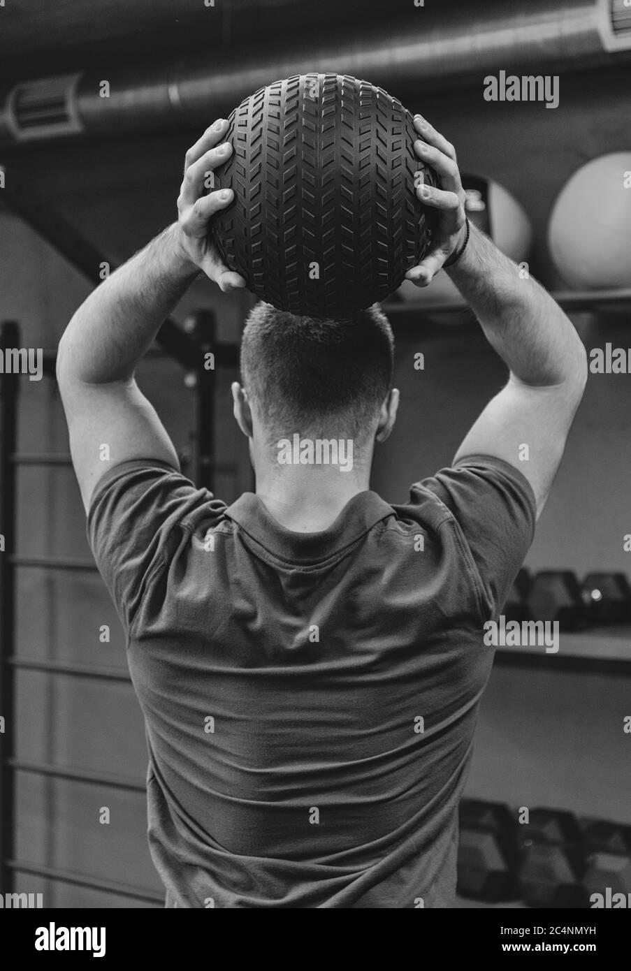 Muscular athletic man exercise with medicine ball at health club or gym ...