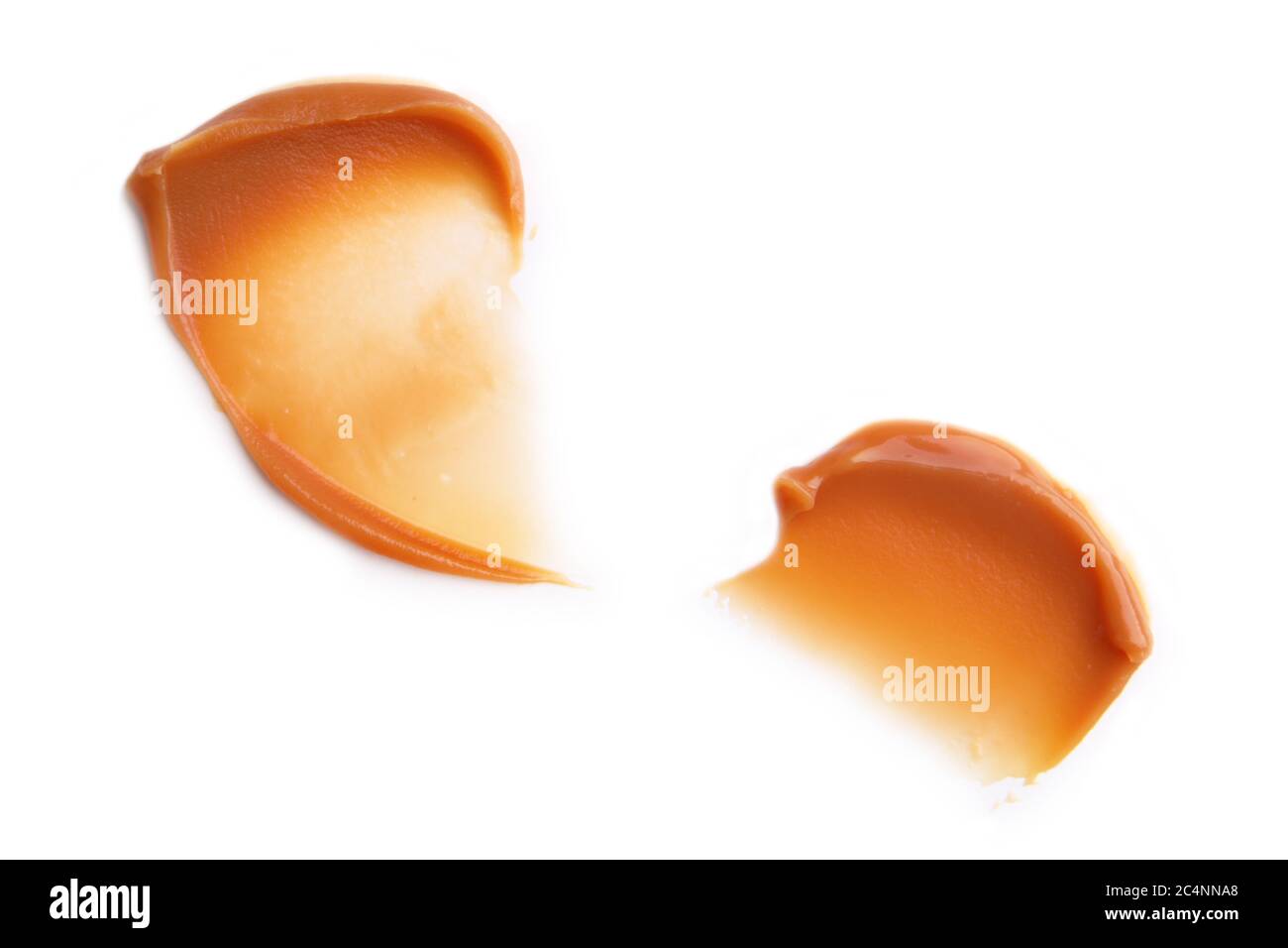 Melted caramel smear isolated on white background Stock Photo - Alamy