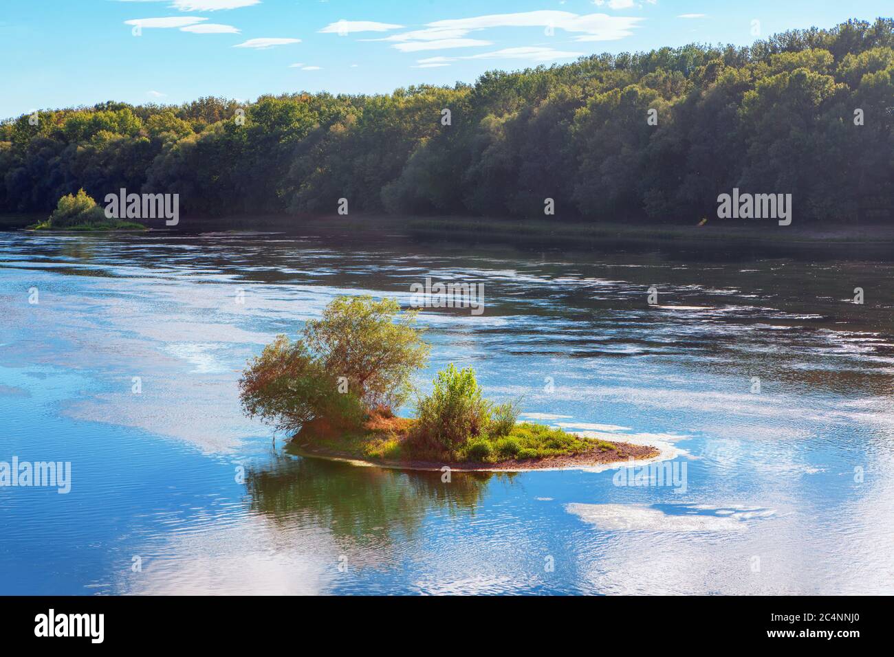Natural little isle in the flowing river water Stock Photo - Alamy
