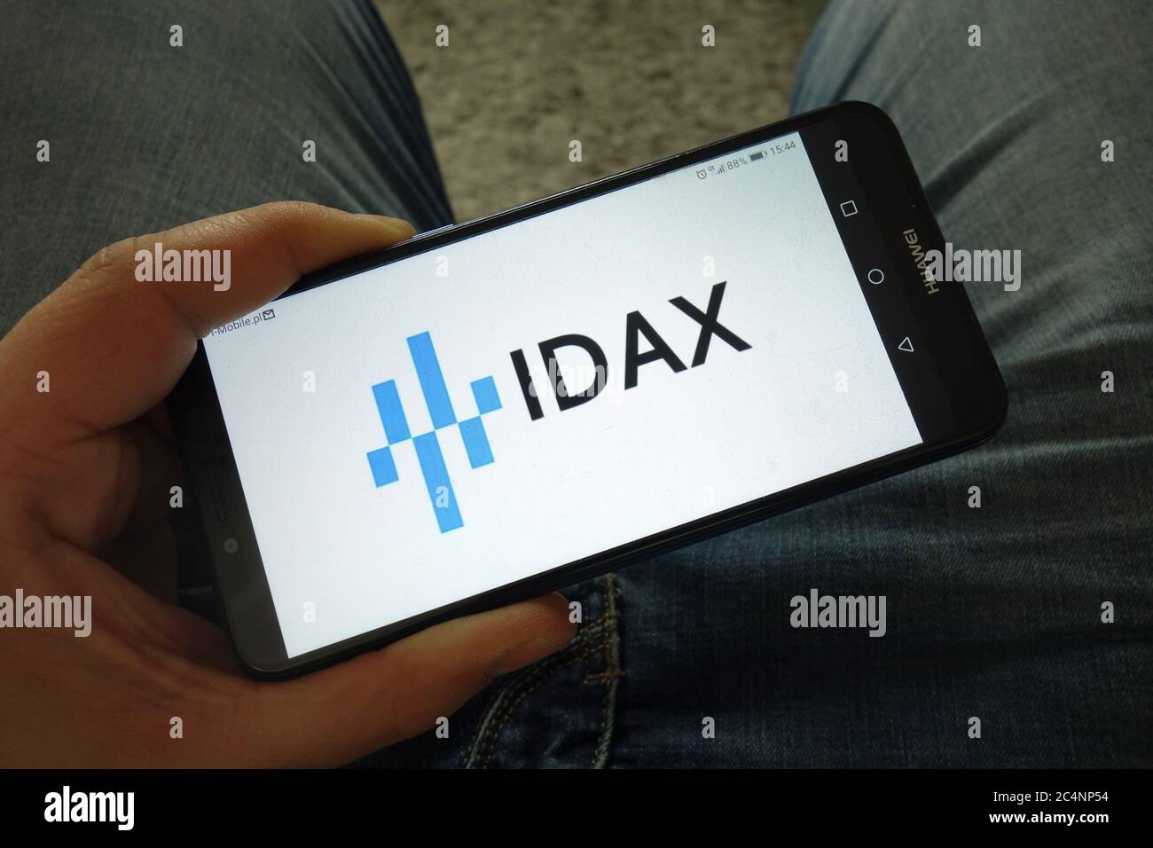 Man holding smartphone with IDAX cryptocurrency exchange logo Stock Photo - Alamy