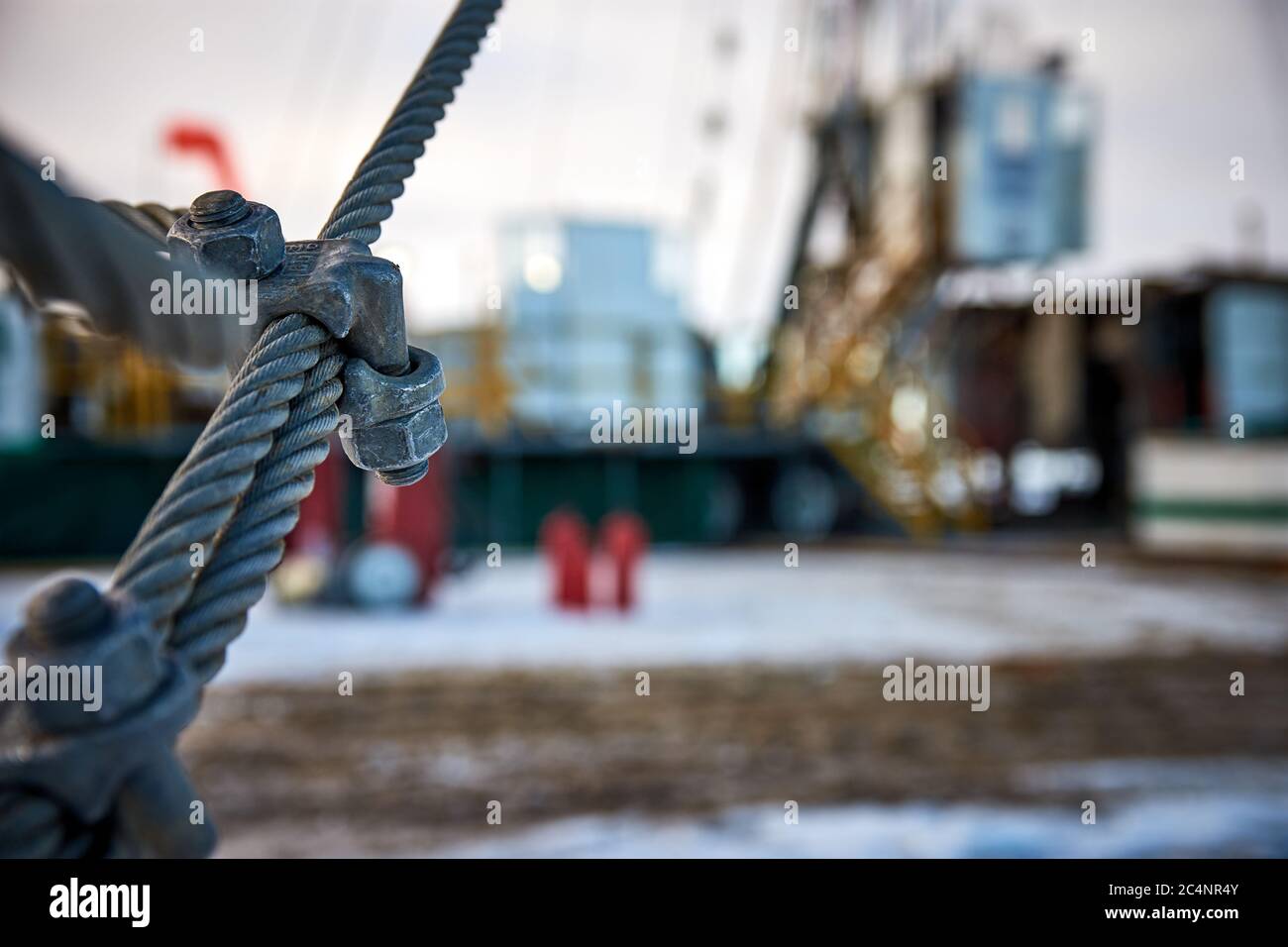 Selective focus shot of a twisted wire rope with a blurred port on ...