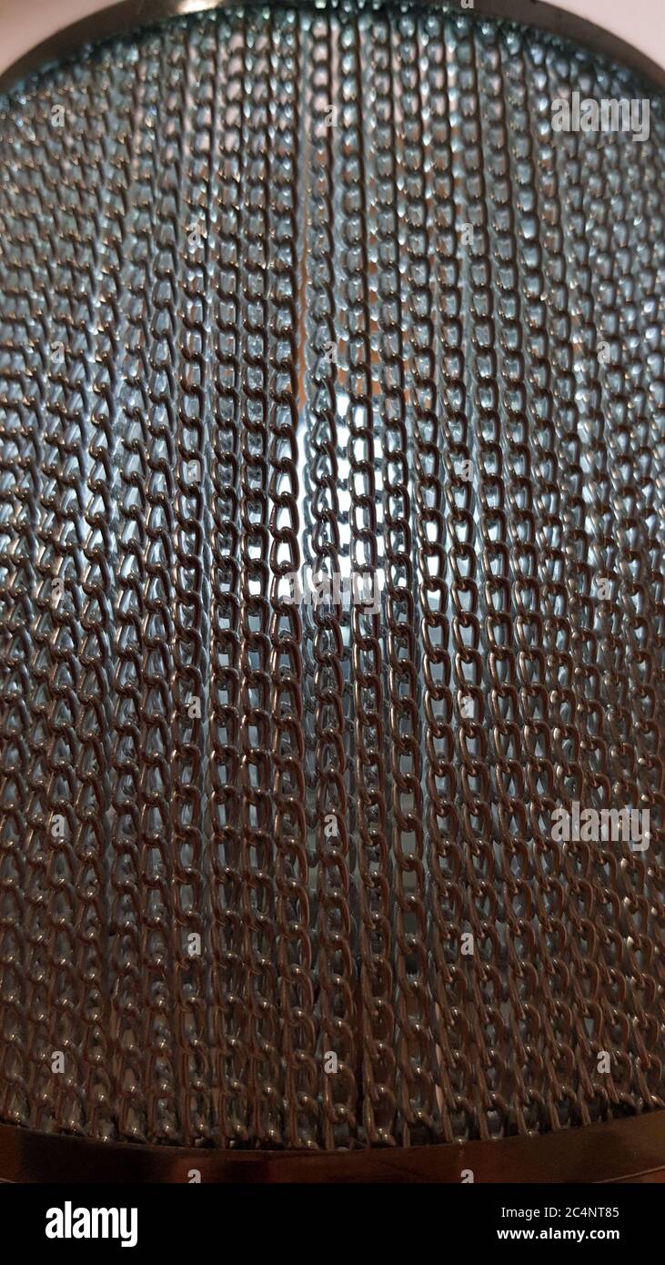 Unusual curtain made from chains hanging in rows. Texture of rough grey ...