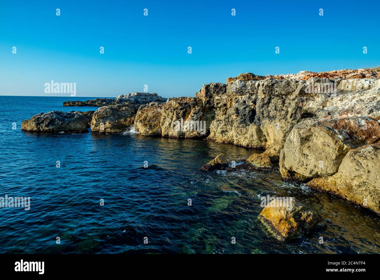 the rocks on the beach on a beautiful summer day and the sky is blue ...