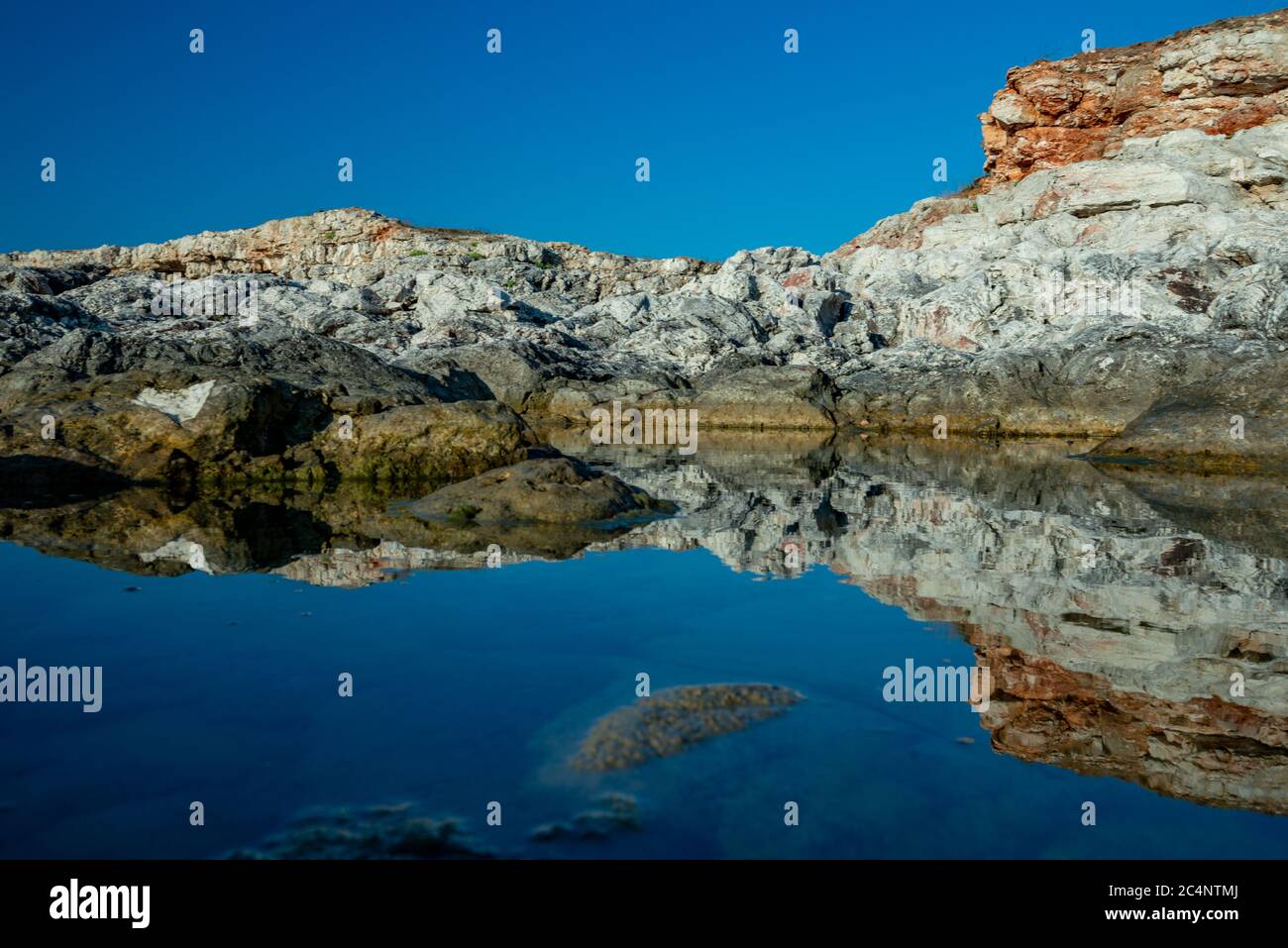 the rocks on the beach on a beautiful summer day and the sky is blue ...