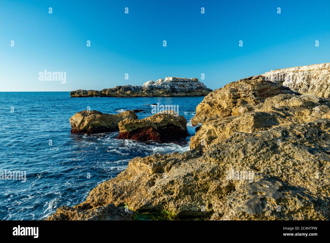 the rocks on the beach on a beautiful summer day and the sky is blue ...