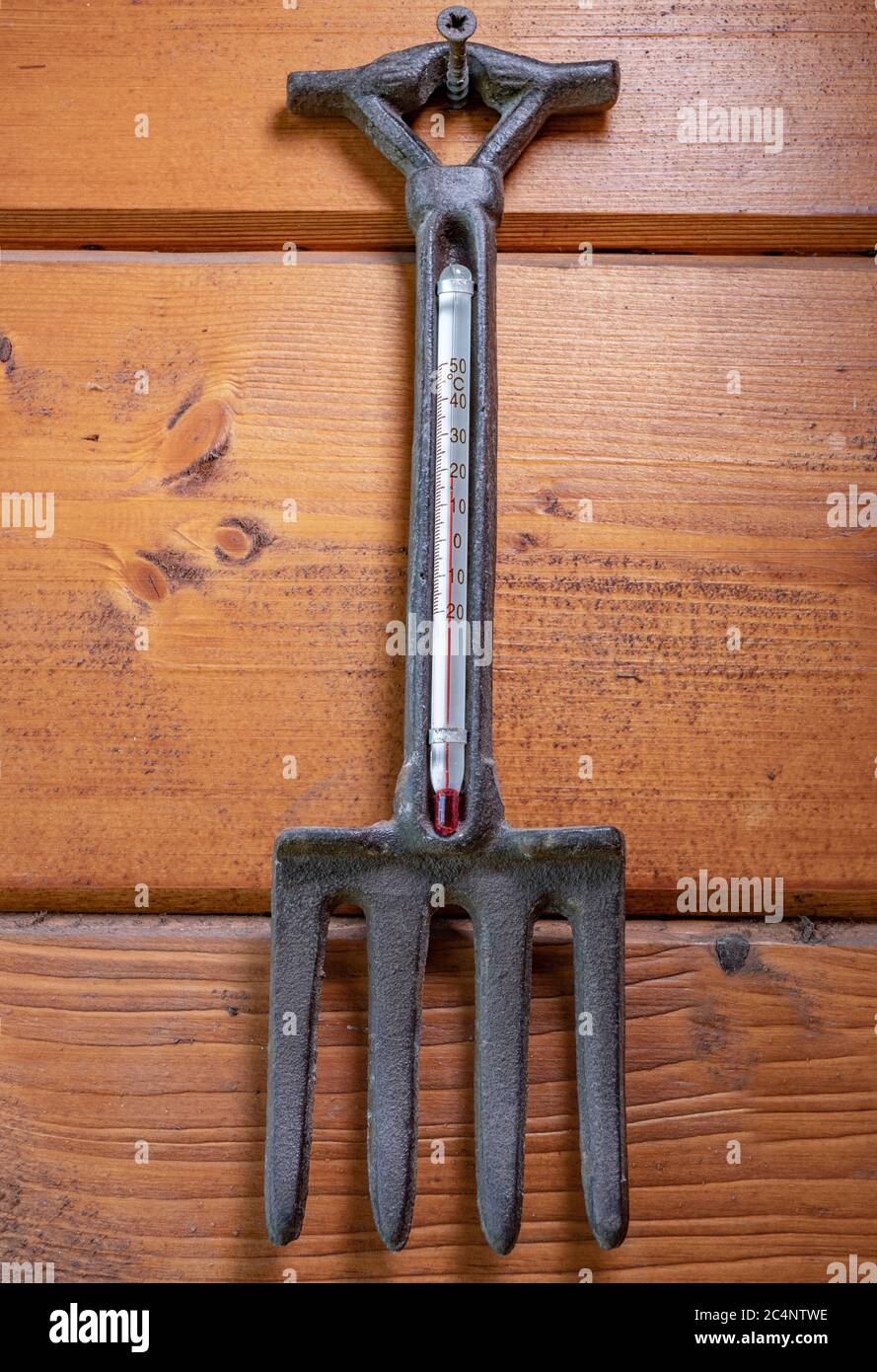 A thermometer inside an iron digging fork, attached to a wooden ...