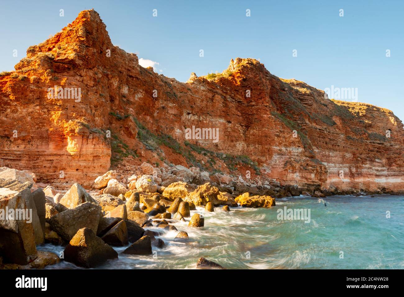 the rocks on the beach on a beautiful summer day and the sky is blue ...