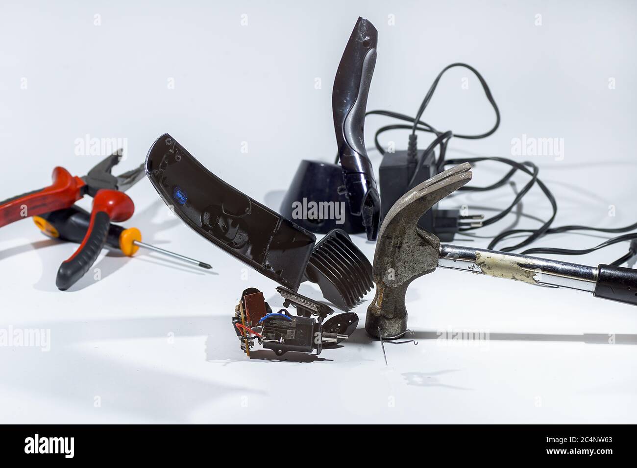 Closeup shot of different parts of an electric razor with tools in ...