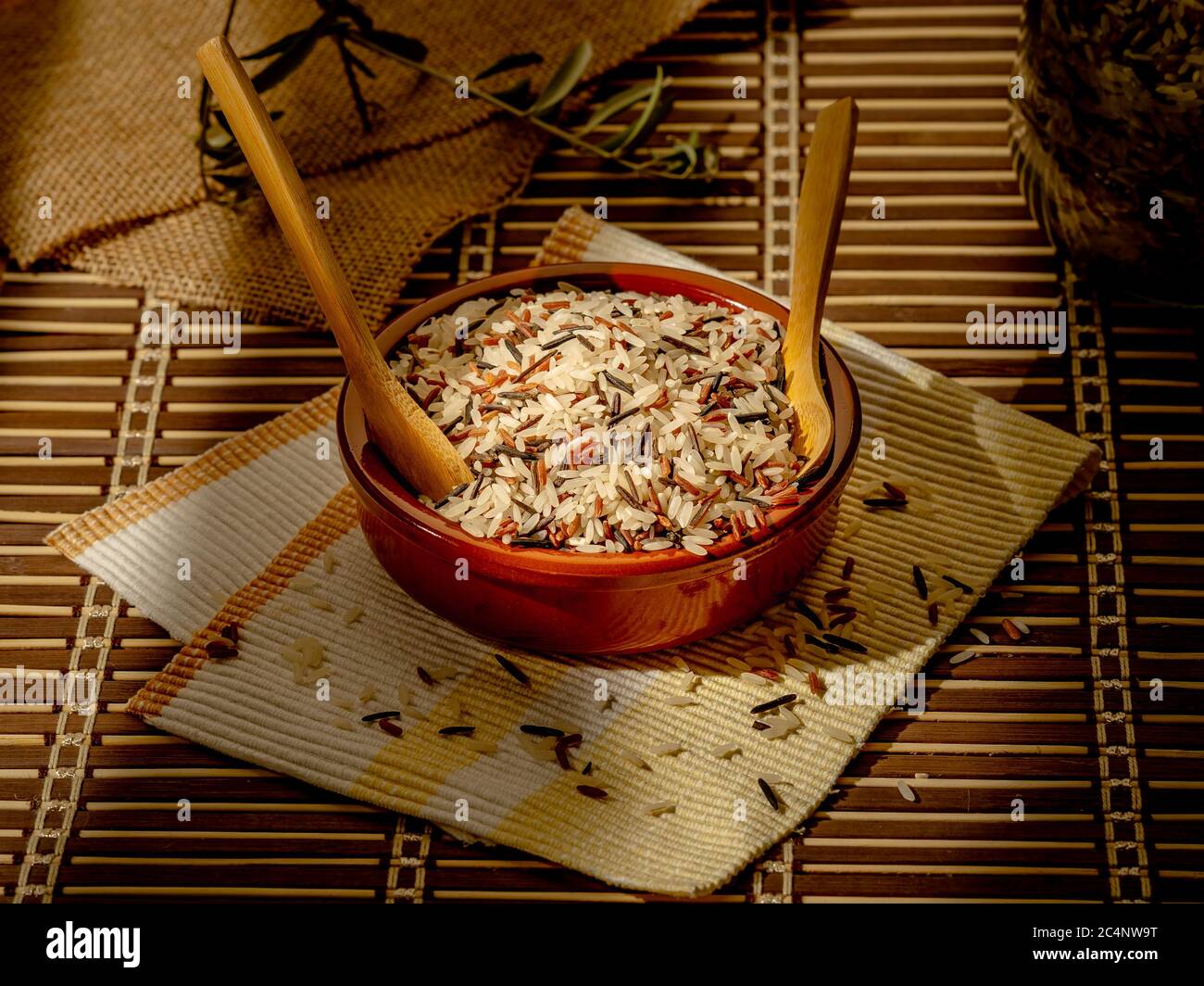 Closeup shot of long grain wild rice in a plate with wooden spoons on a ...