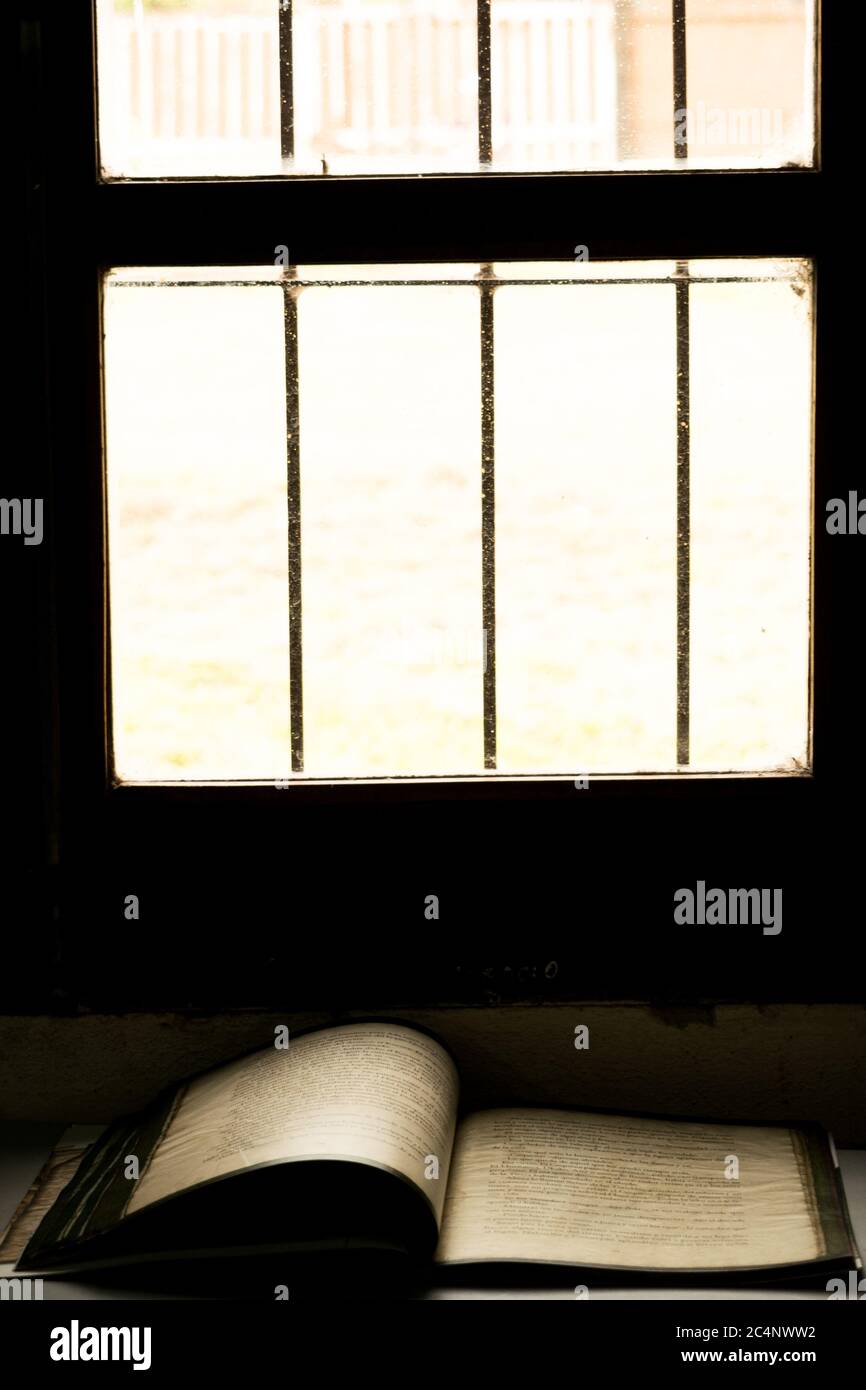 Vertical shot of an old book placed on a table under the window Stock ...