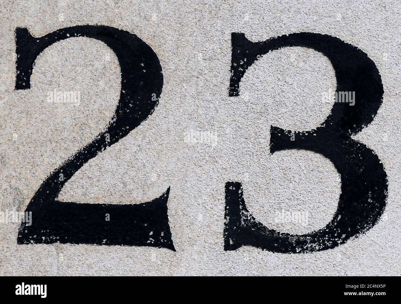 A Close Up Of The Number Twenty Three Painted In Black On A White Wall ...