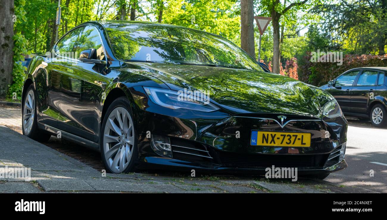 NIJMEGEN, THE NETHERLANDS, MAY 5 2020: A Tesla standing next to a road ...