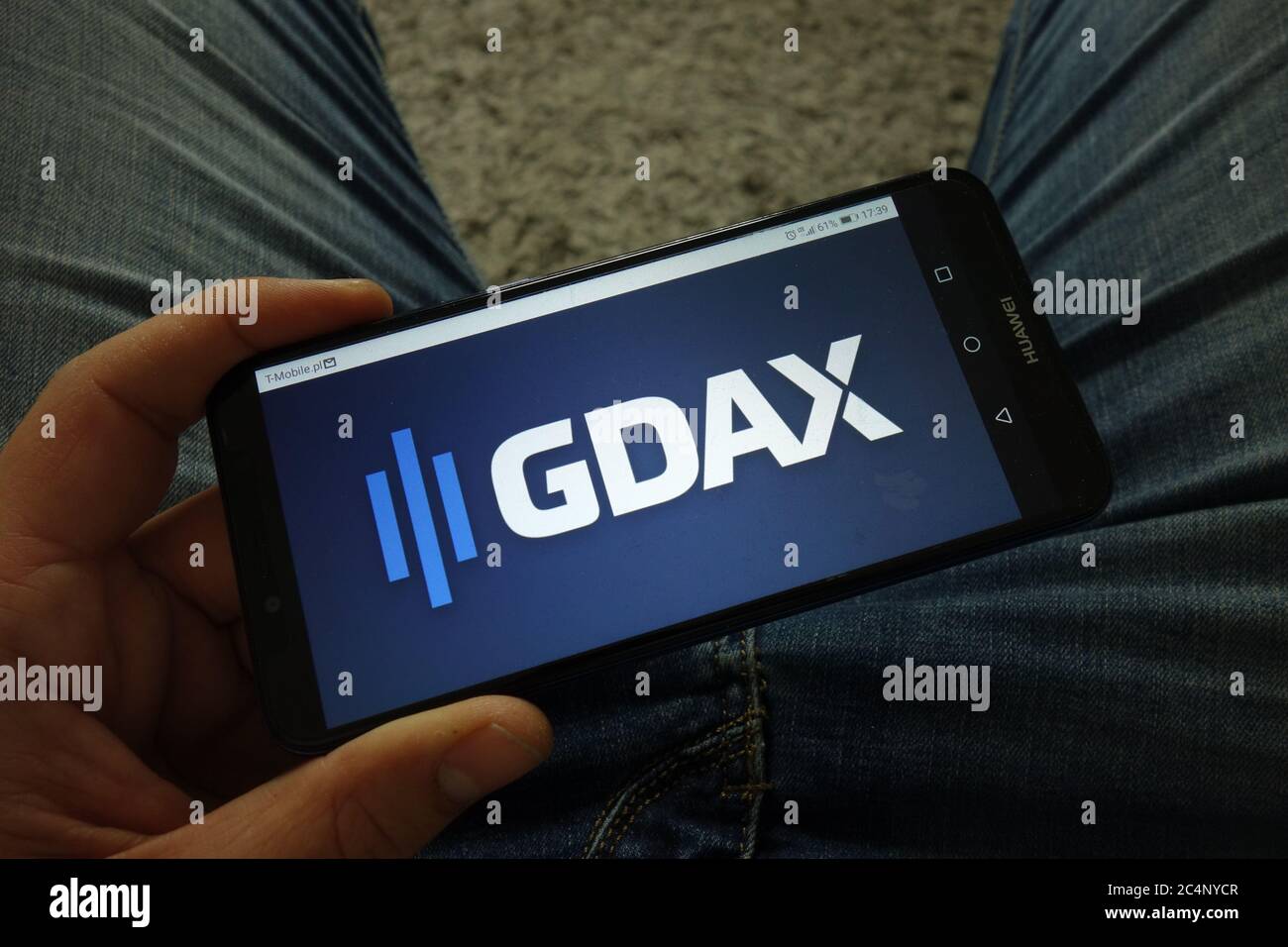Man holding smartphone with Gdax cryptocurrency exchange logo Stock Photo - Alamy