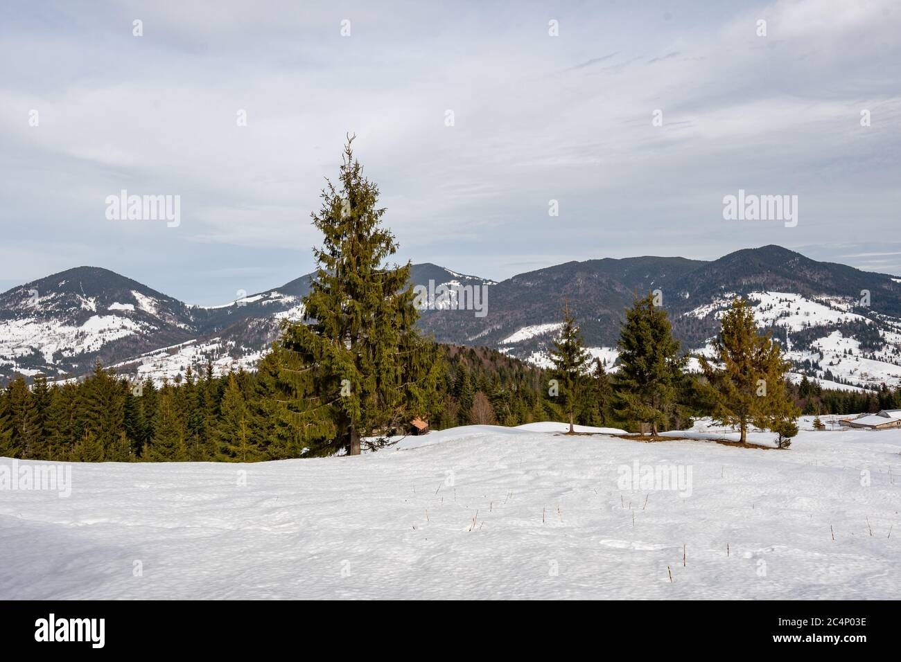 rocky mountains full of snow and villages in the valley Stock Photo - Alamy