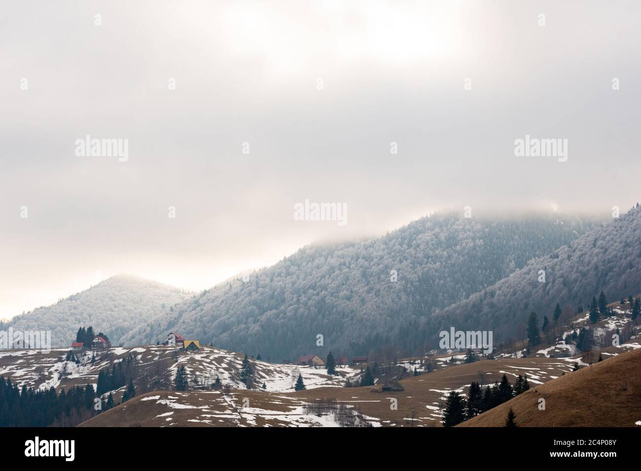 rocky mountains full of snow and villages in the valley Stock Photo - Alamy