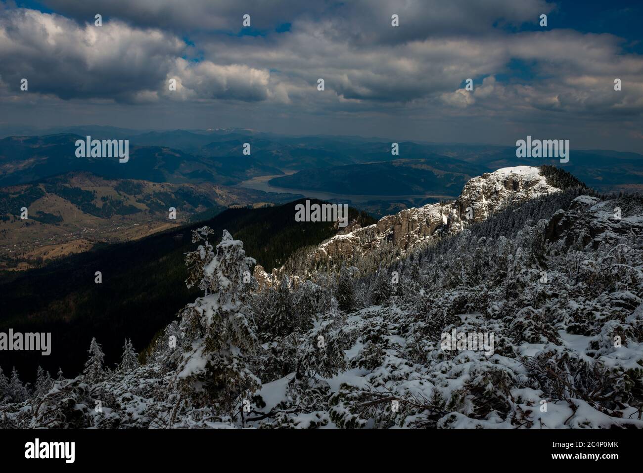 rocky mountains full of snow and villages in the valley Stock Photo - Alamy