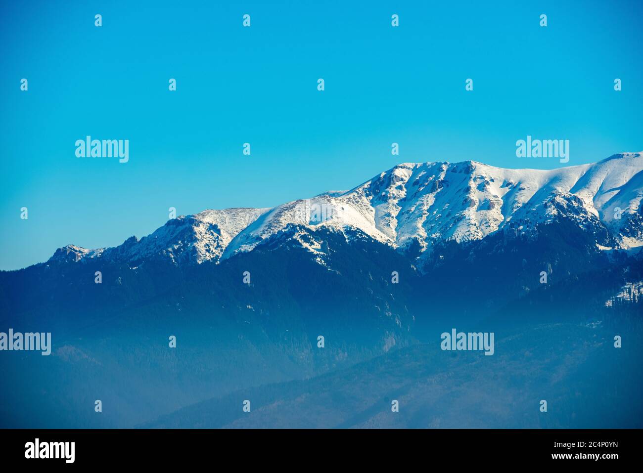 rocky mountains full of snow and villages in the valley Stock Photo - Alamy