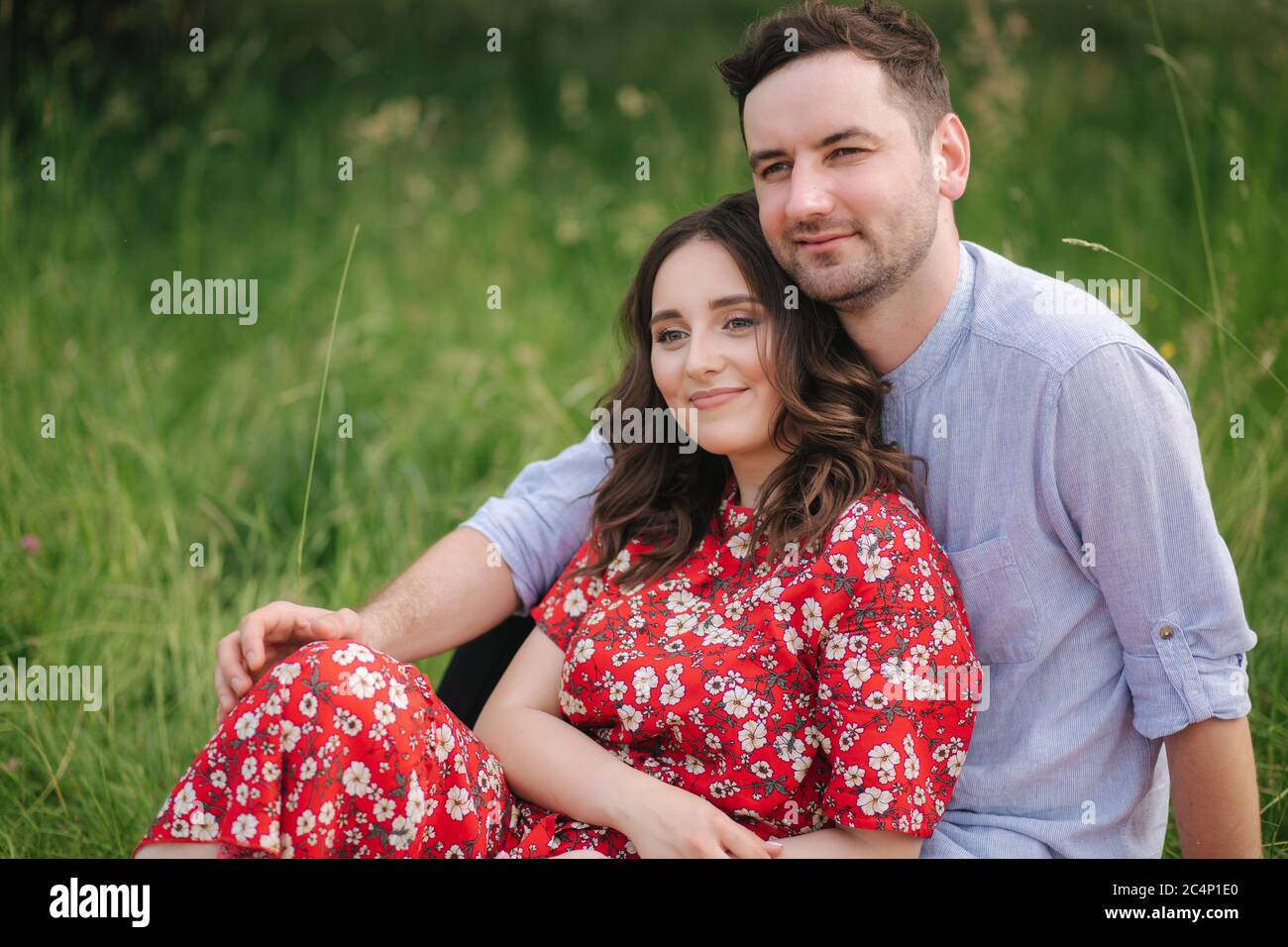 Portrait of beautiful man and woman sitting outdoors Stock Photo - Alamy
