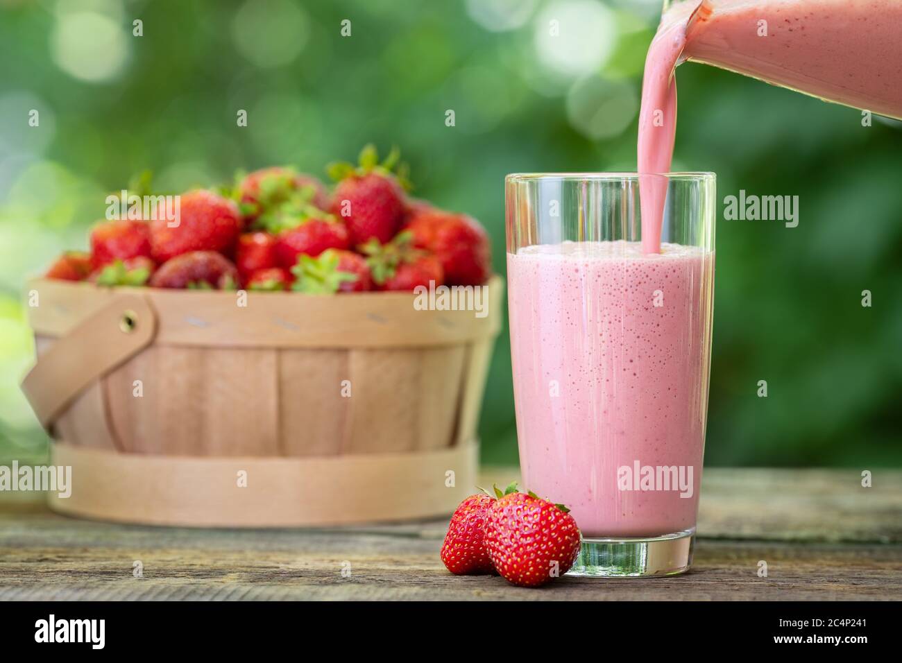 strawberry milkshake pouring in glass Stock Photo - Alamy