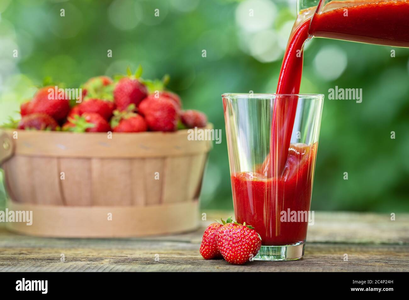 strawberry smoothie pouring in glass Stock Photo - Alamy