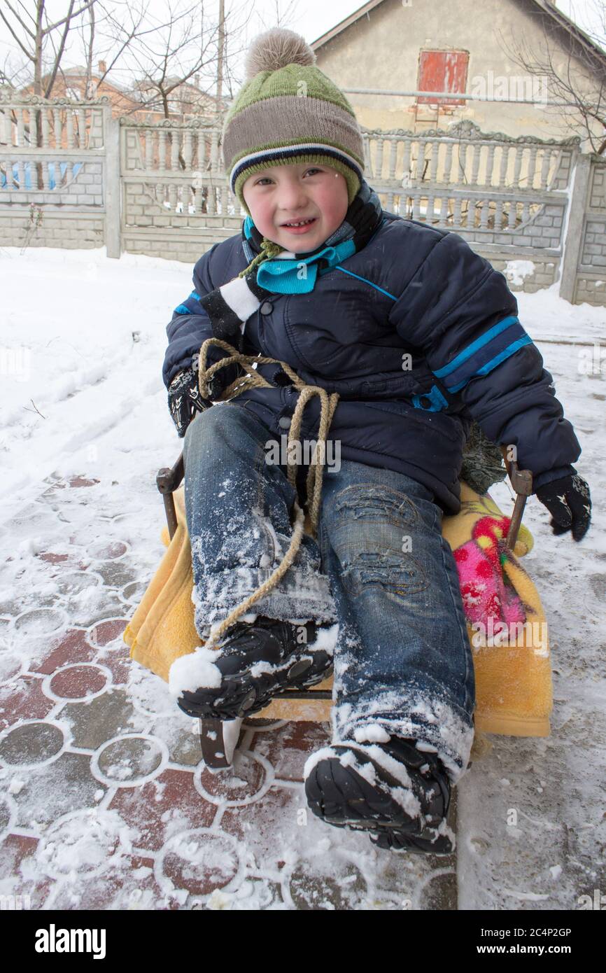 Boy and sled Stock Photo - Alamy