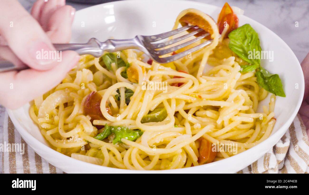 Step by step. Serving a one-pot pasta into a white pasta plate Stock ...