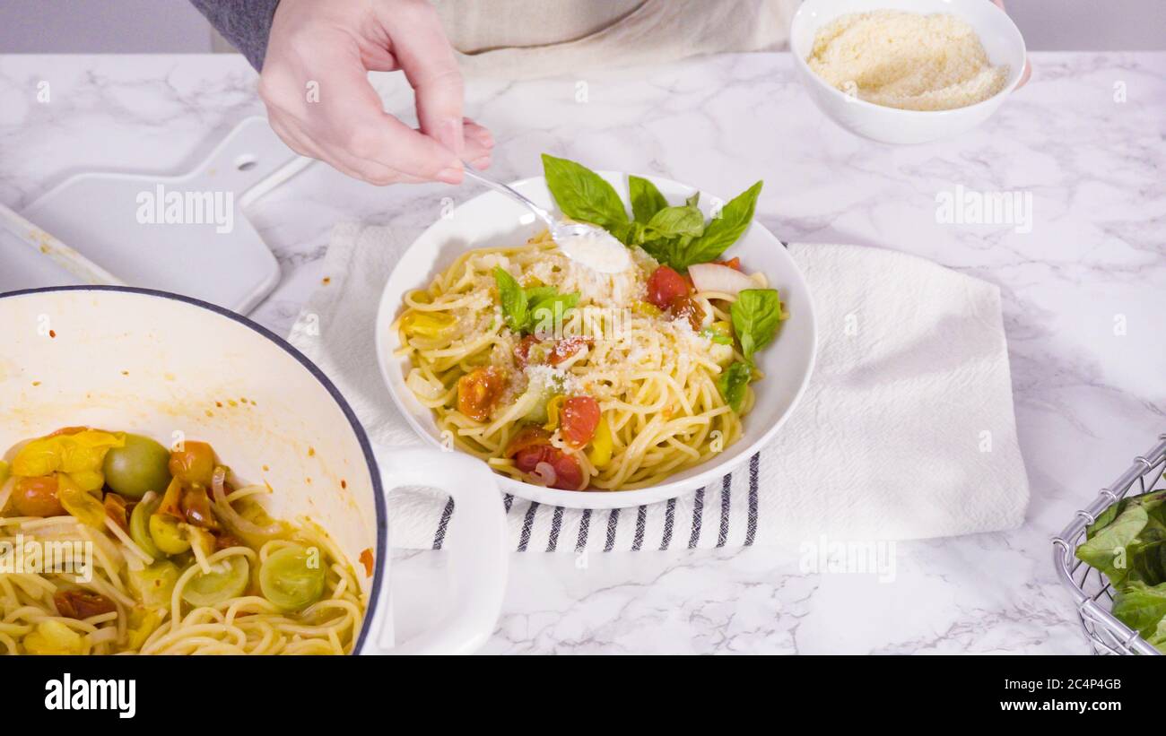 Step by step. Serving a one-pot pasta into a white pasta plate Stock ...