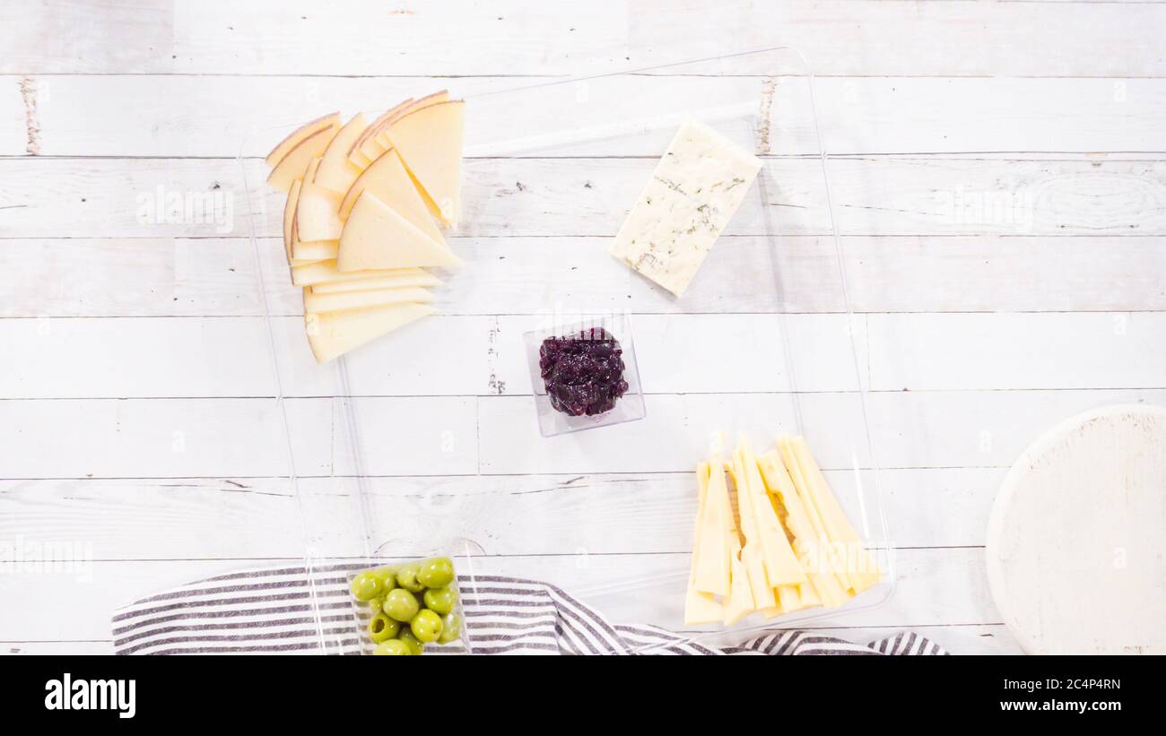 Flat lay. Step by step. Arranging cheese platter with fresh fruits ...