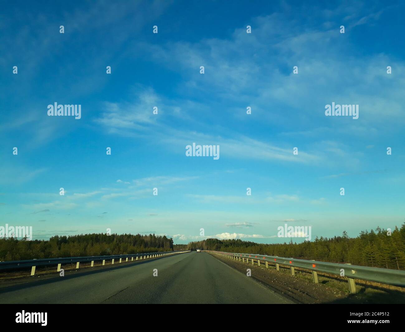 A road or highway leading to the horizon. View from the car window ...