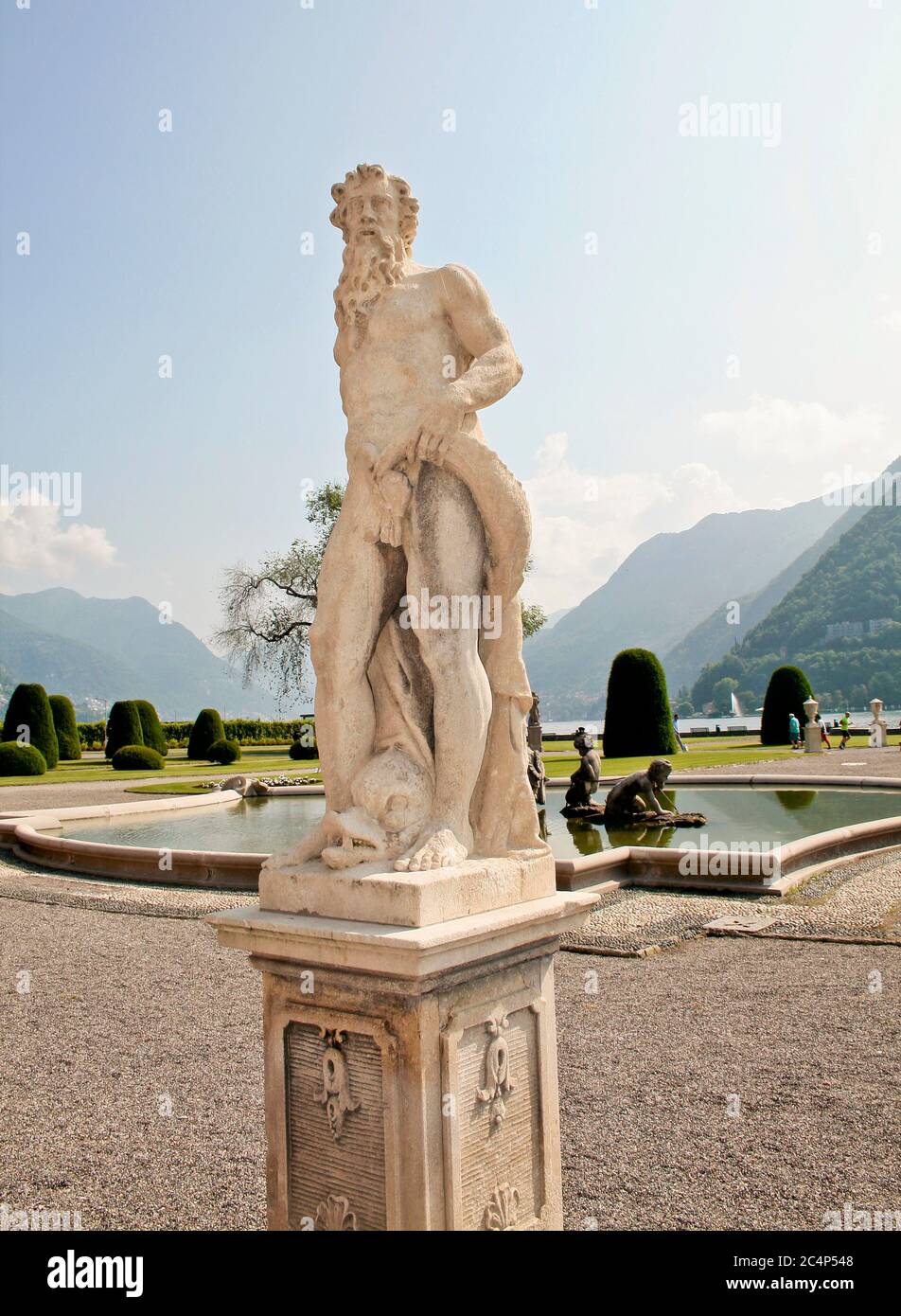 Como, Lombardy, Italy. One of the marble statues representing pagan ...