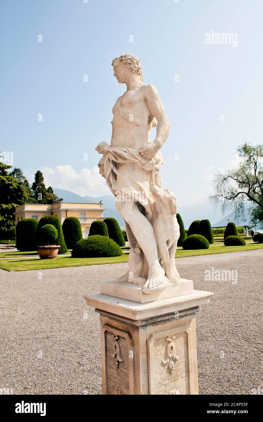 Como, Lombardy, Italy. One of the marble statues representing pagan ...