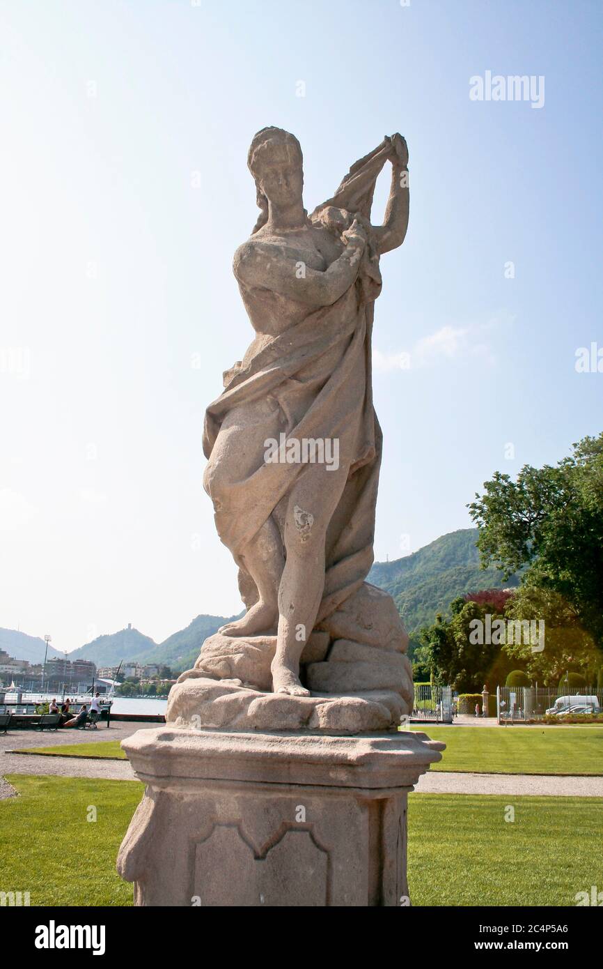 Como, Lombardy, Italy. One of the marble statues representing pagan ...