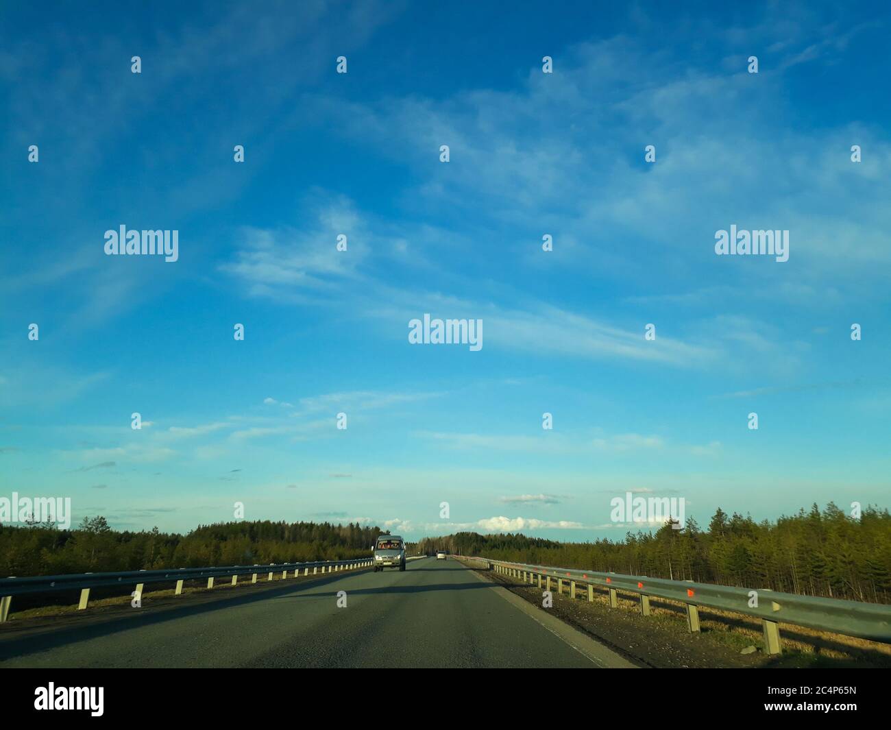 A road or highway leading to the horizon. View from the car window ...