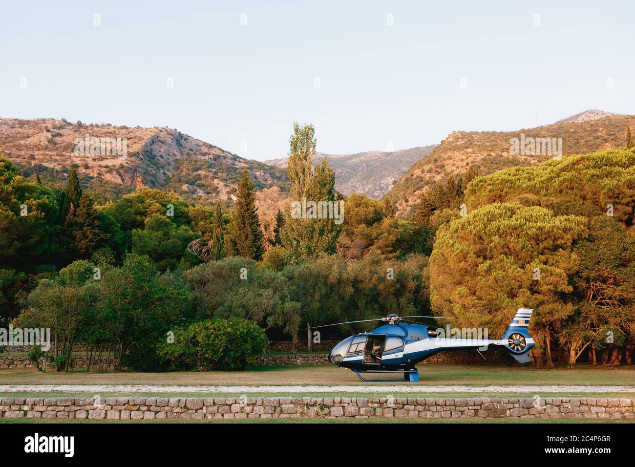 Passenger helicopter landed in the park, against the backdrop of the ...