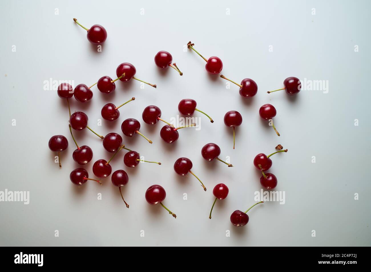 Group of cherry on a white background with shadows. Close-up. Top view ...