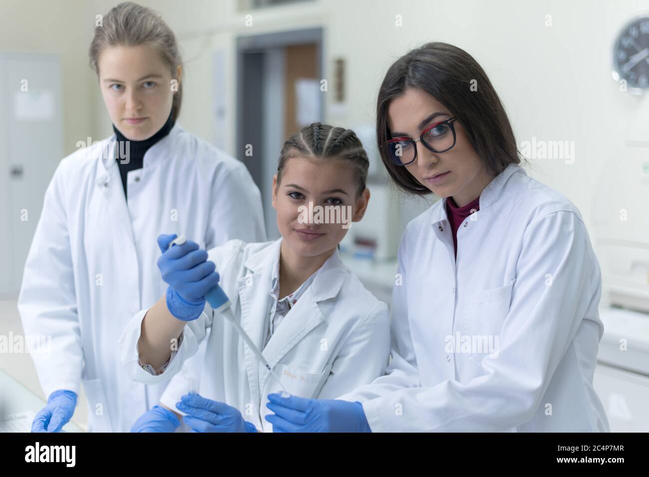 Group of Laboratory scientists working at lab with test tubes, test or ...