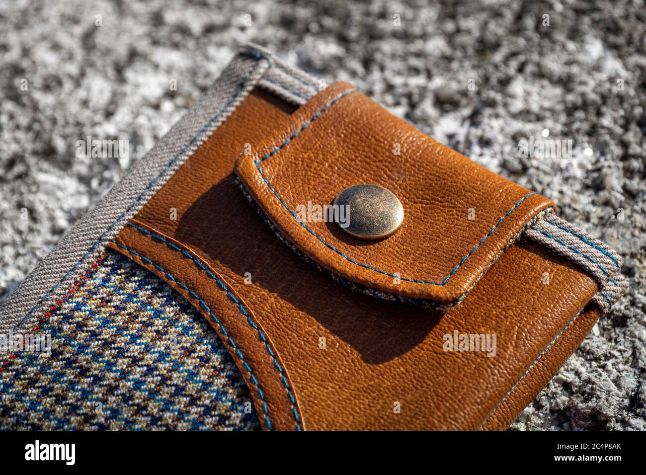 Rivet of handmade wallet of brown leather and checkered textile on ...