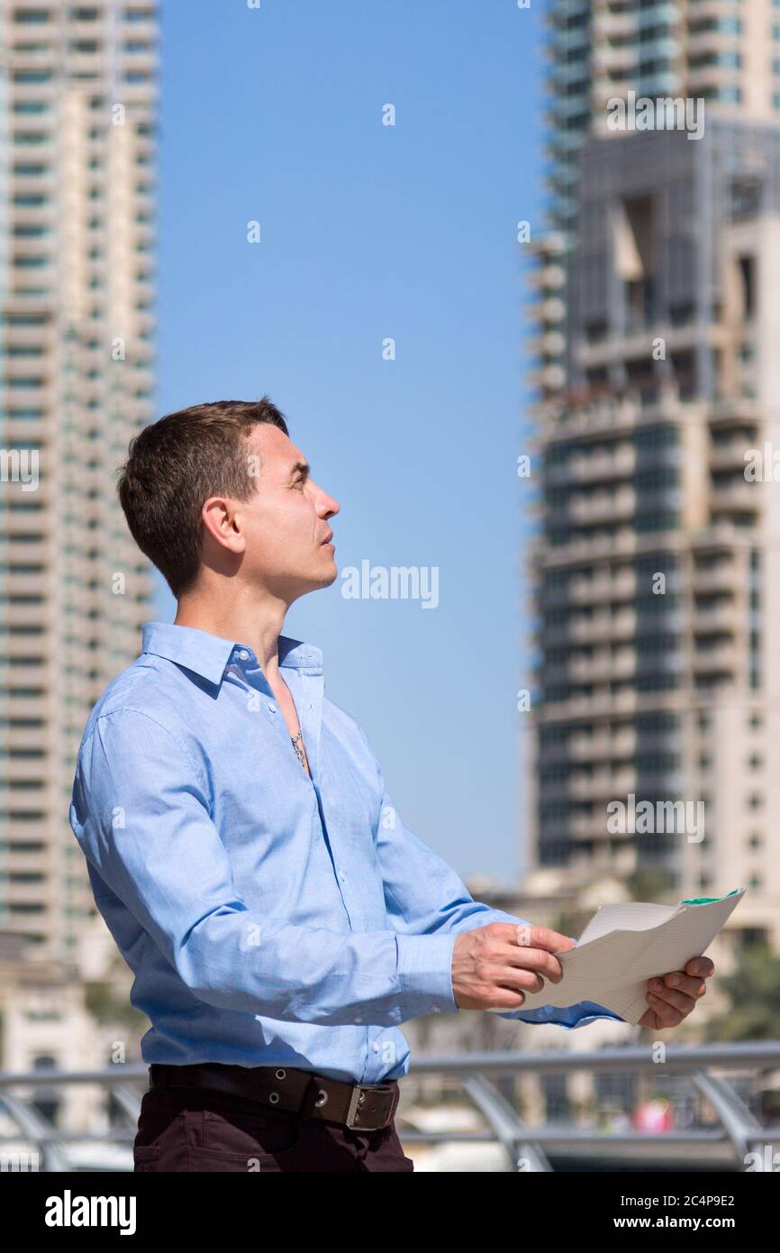 Business man with a plan diagram in his hands in the city center Stock ...