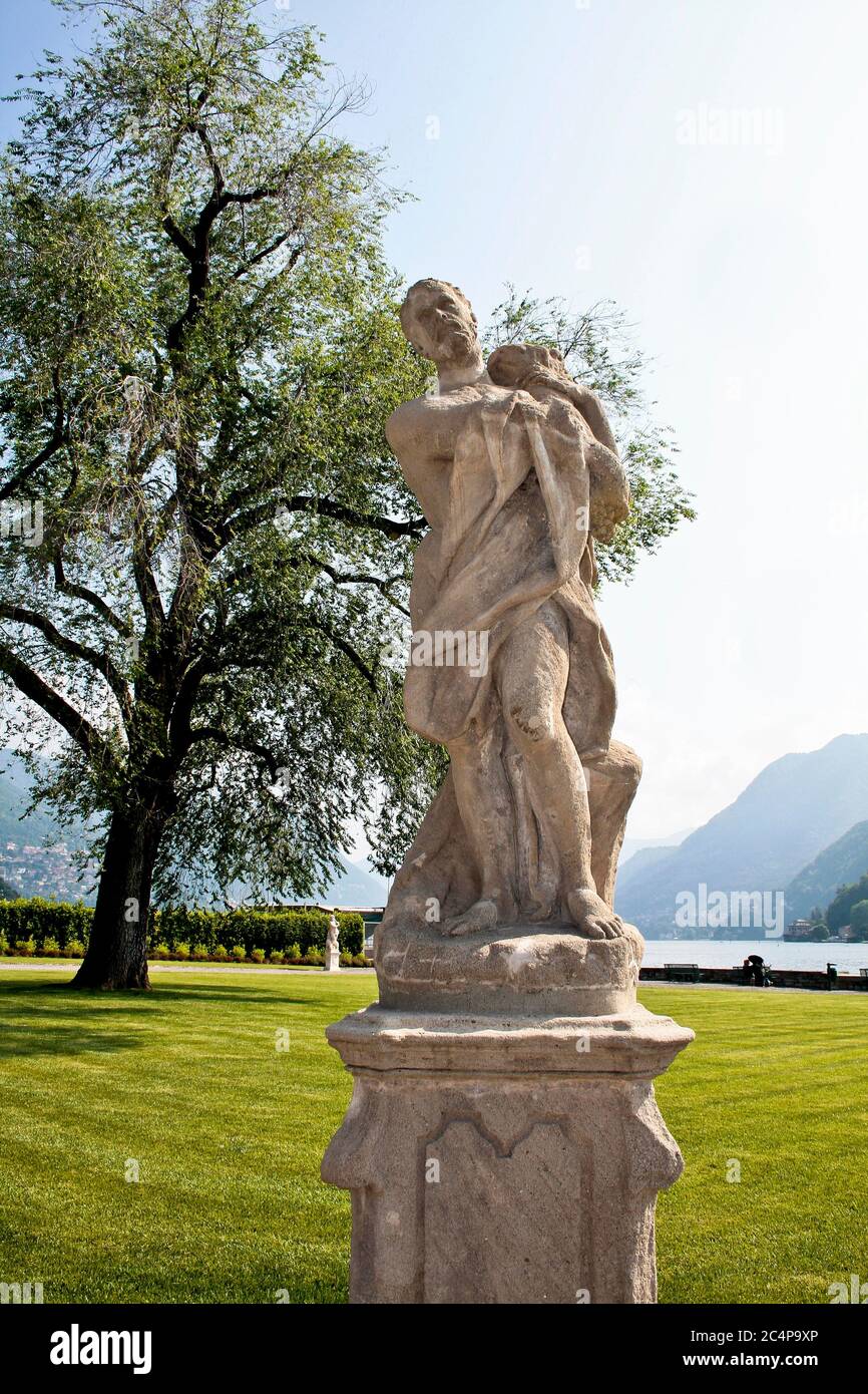Como, Lombardy, Italy. One of the marble statues representing pagan ...