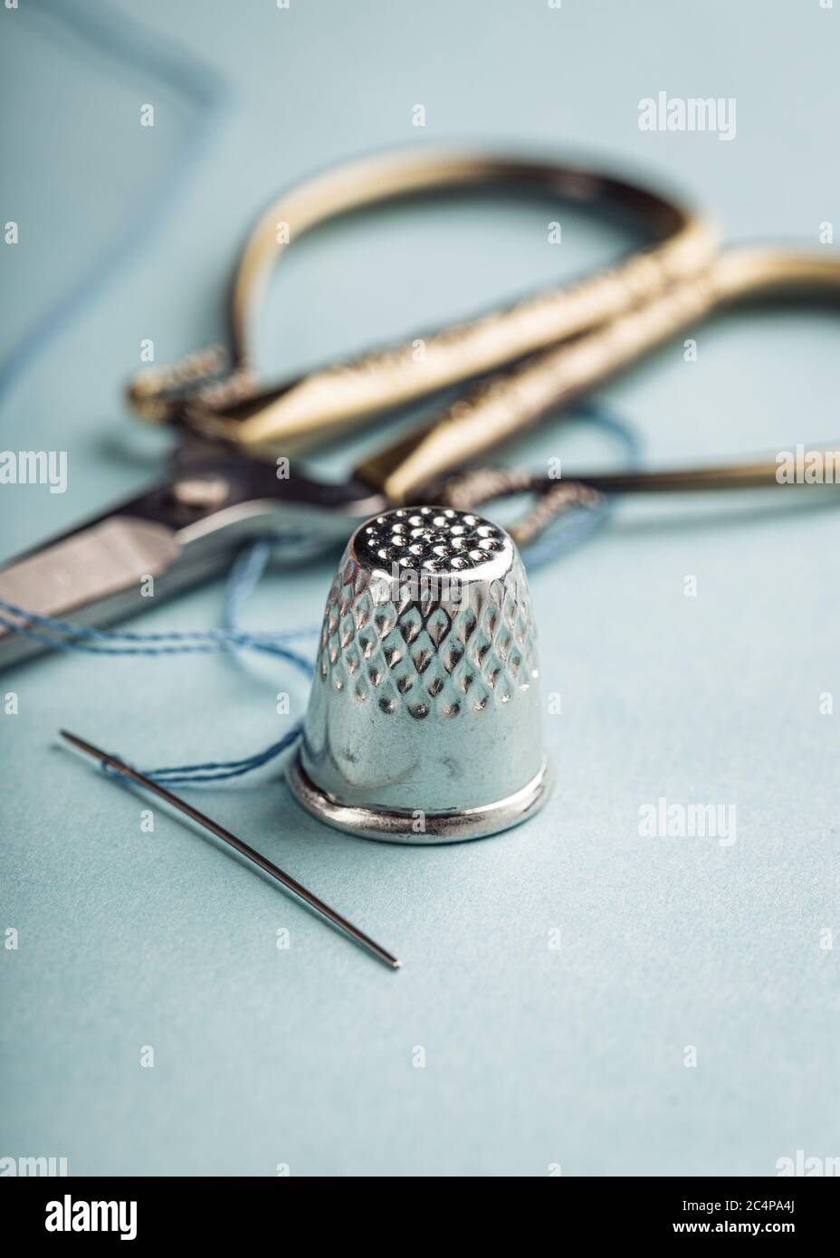 vintage silver thimble on blue Stock Photo - Alamy