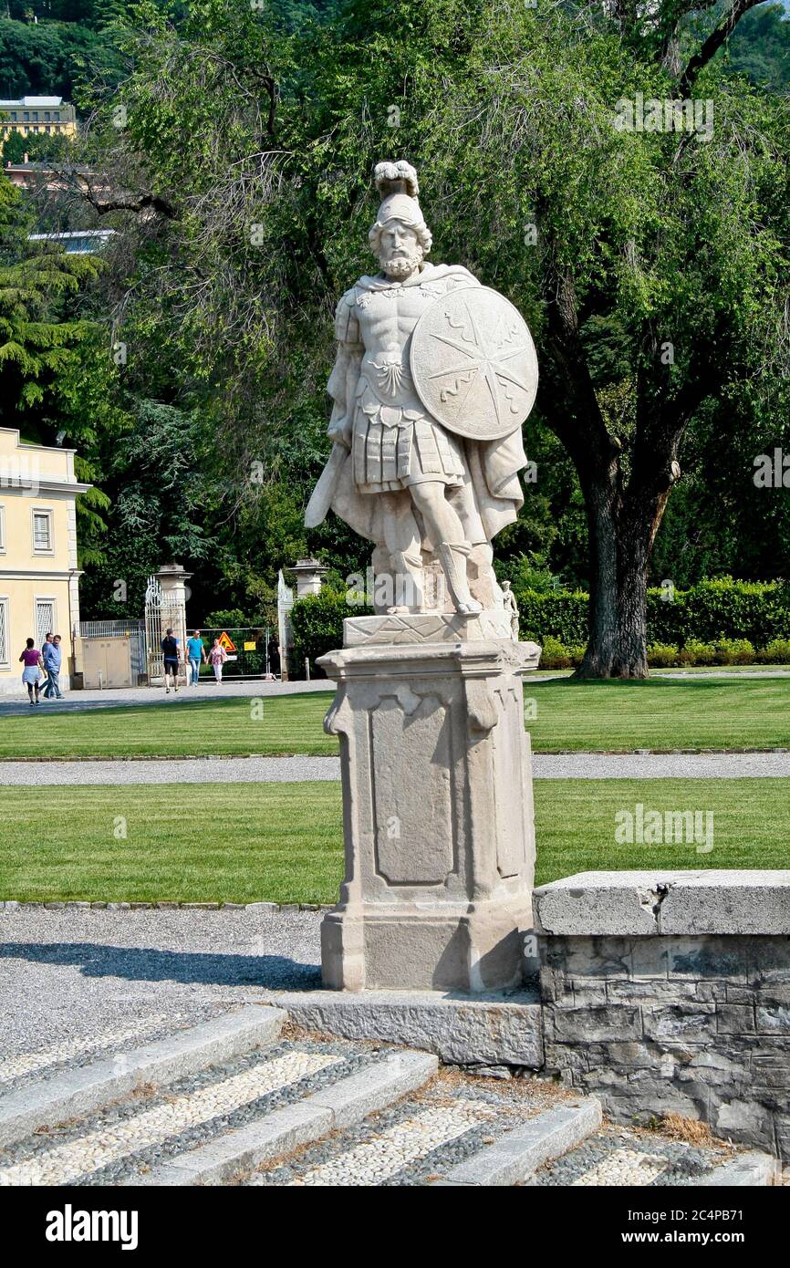 Como, Lombardy, Italy. One of the marble statues representing pagan ...