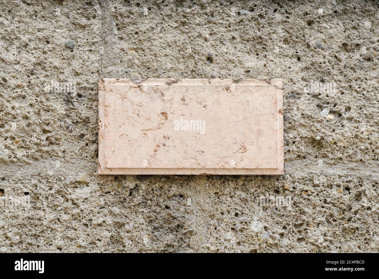 Old stone blank sign plate on ancient wall, with copy space for your ...
