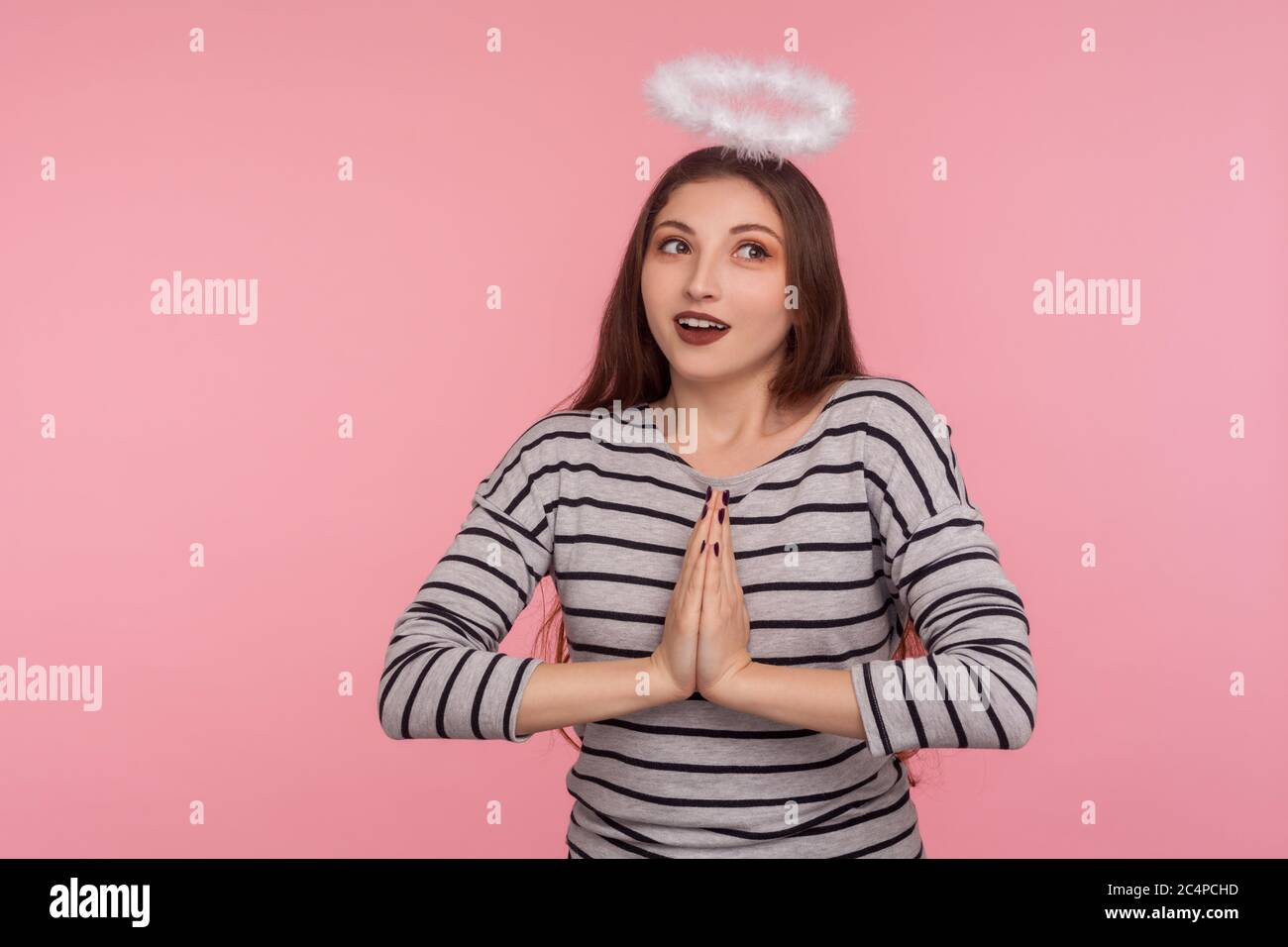 I'm saint angel! Portrait of lovely kind modest woman with holy nimbus ...