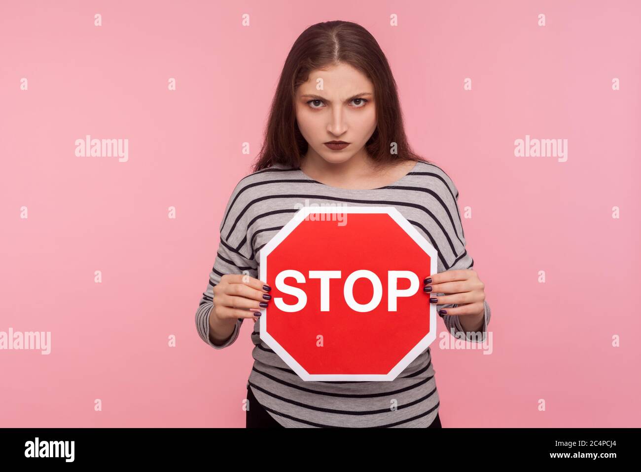 Way prohibited! Portrait of angry strict bossy girl in striped ...