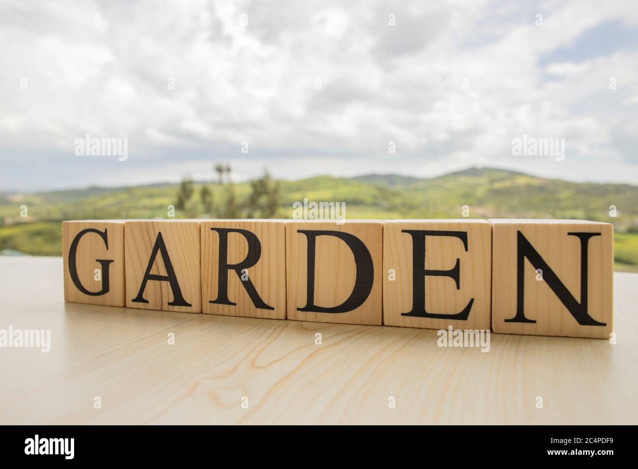 GARDEN text made of wooden cube on nature background. Close up Stock ...